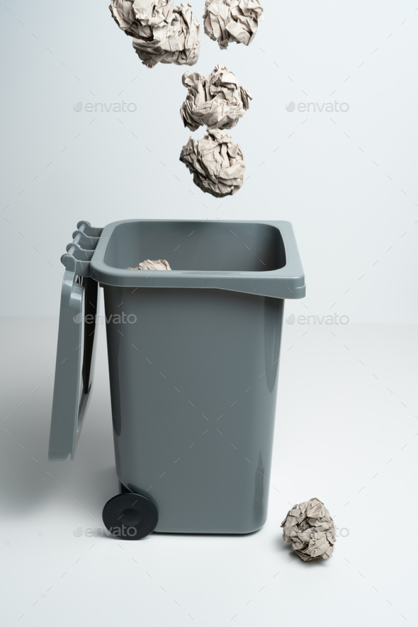 Paper flying into the trash can Stock Photo by Pasanheco | PhotoDune