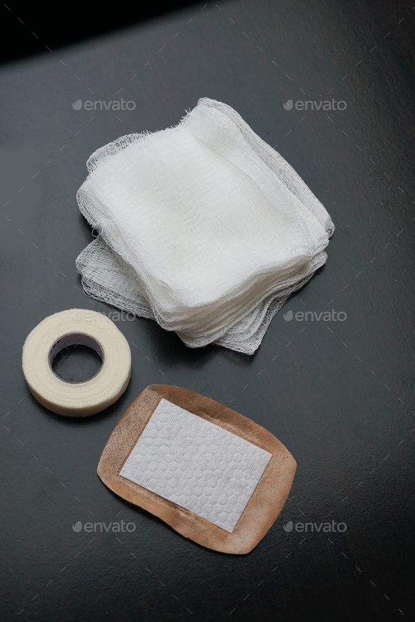 Gauze pads bandage and scissors used to control bleeding for first aid ...