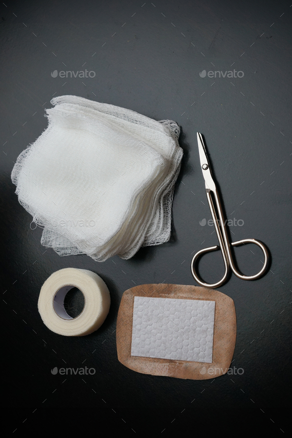 Gauze pads bandage and scissors used to control bleeding for first aid ...