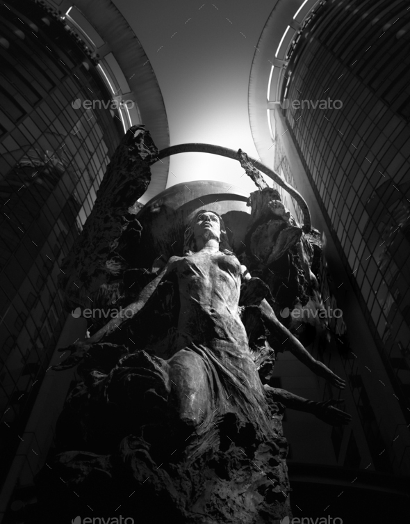 an abstract sculpture with multiple heads sitting on a statue and two ...