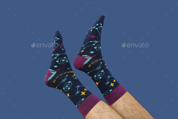 Colored socks with a print on men's feet. Stock Photo by AtlasComposer