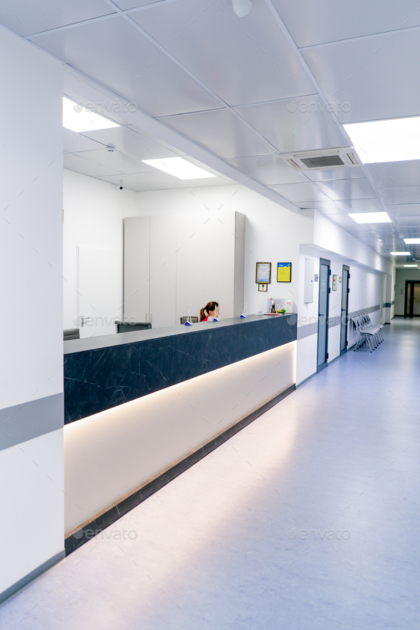 hall of a medical center with a reception desk and large long corridor ...