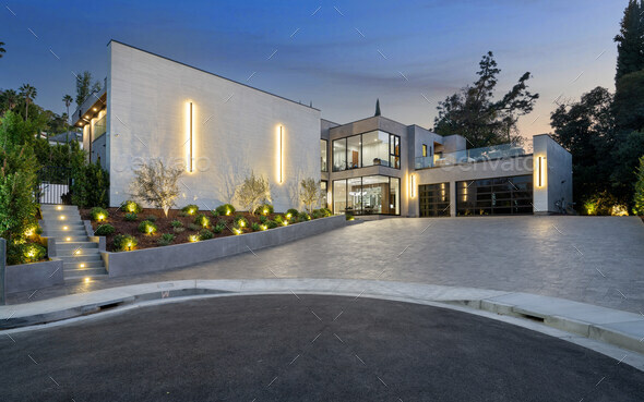 Empty driveway leading to a white building with outdoor light Stock ...