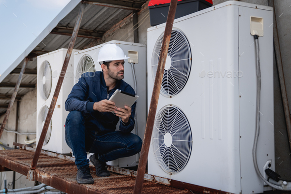 Engineers checking air conditioning cooling system of a major building ...