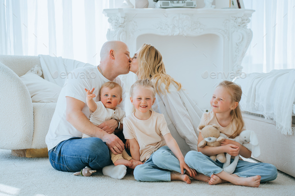Happy family enjoying time together at home Stock Photo by ionadidishvili