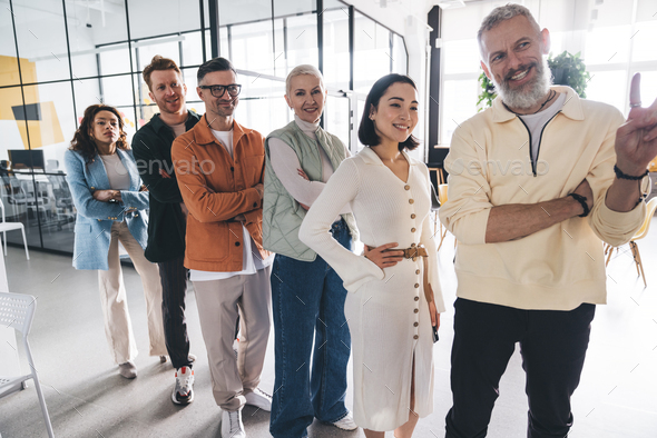 Diverse colleagues standing one behind another in office Stock Photo by ...