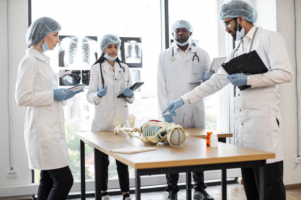 Indian woman teaching anatomy to university students or young doctors ...