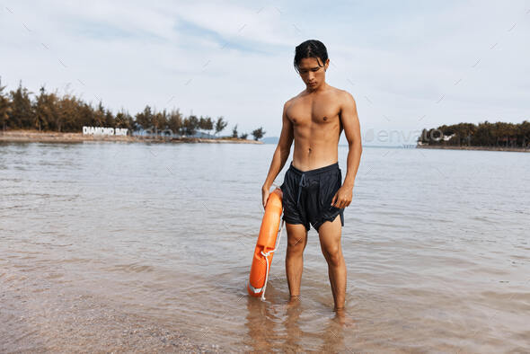 Summer Beach: Asian Lifeguard, a Symbol of Safety and Fun on Sand and ...