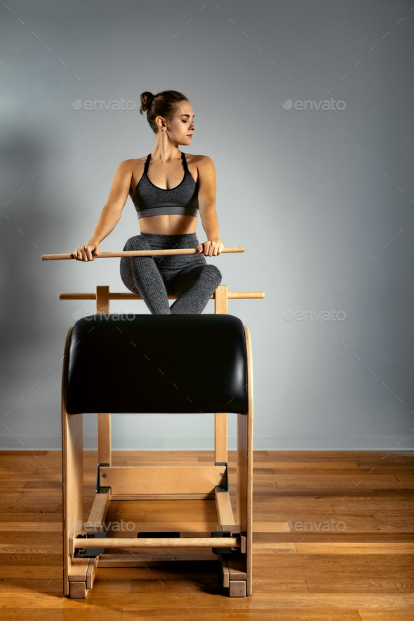 Pilates trainer exercises on a pilates barrel. Body training, perfect ...