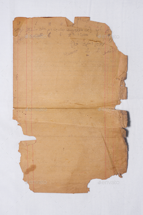 A torn old sheet of lined paper with faint Arabic handwriting Stock ...