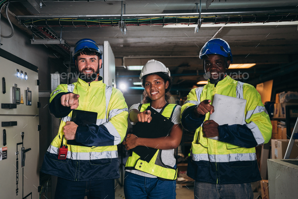Team engineers and foreman stack hand and shake hands to show success ...