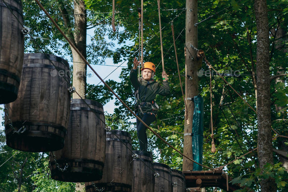 well equipped teenage boy in outdoor passing obstacle course. Active ...
