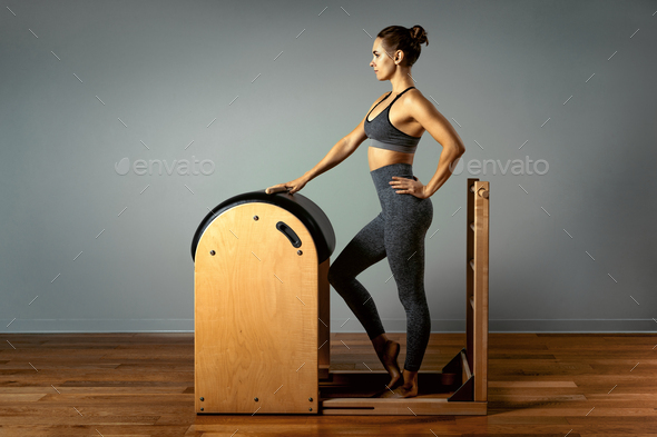 Pilates, fitness, sport, training and people concept - woman doing ...