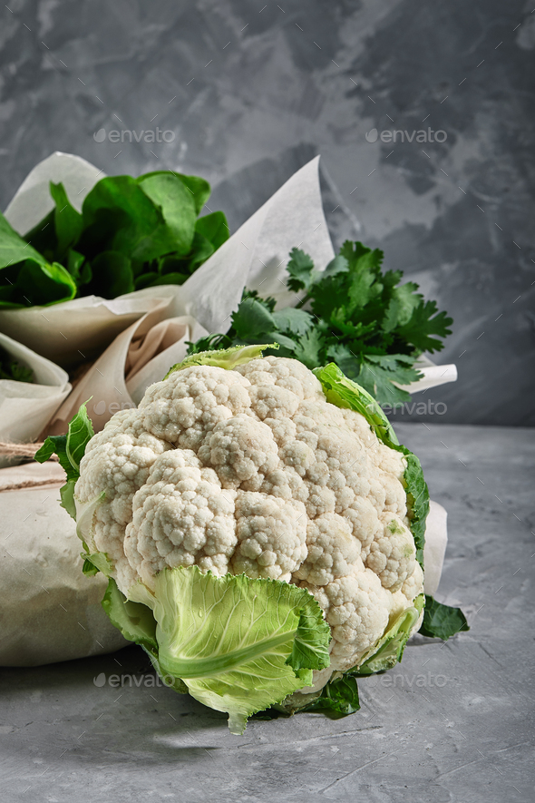 Fresh cauliflower on a gray concrete background. on packaging material, paper bags, eco-friendly ...