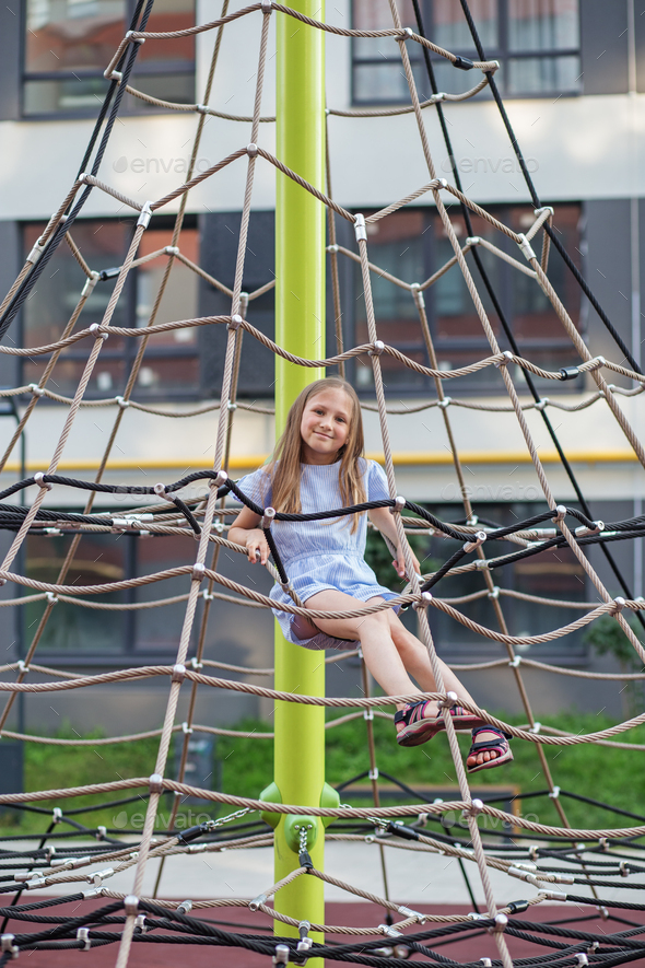 Preteen Child Climbing Rope Structure at Playground Stock Photo by ...
