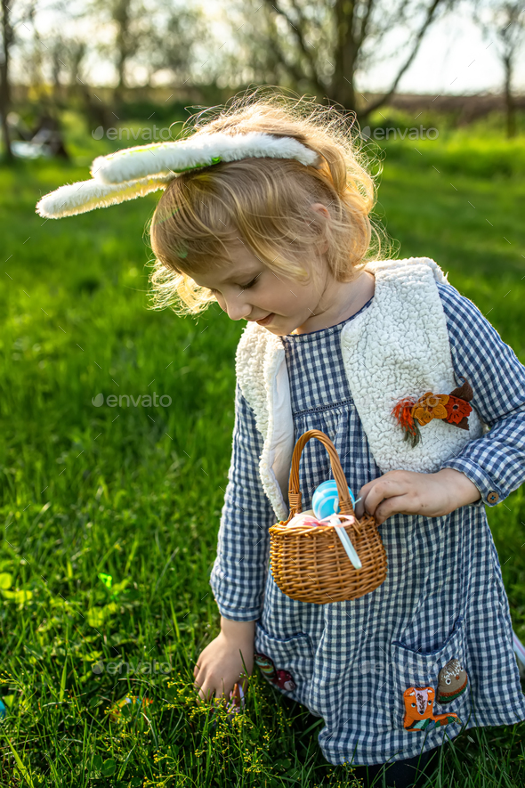 Little adventurer on an Easter quest . child exploring the garden, in ...