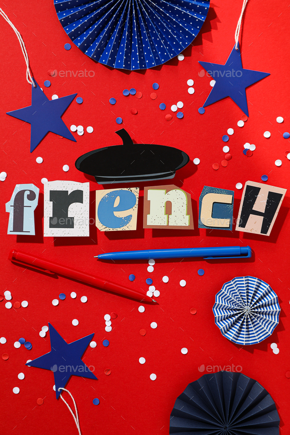 The word French on a red background, top view. Stock Photo by AtlasComposer
