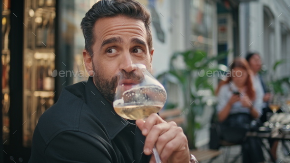 Man model enjoying alcohol summer cafe bar close up. Guy drinking wine ...