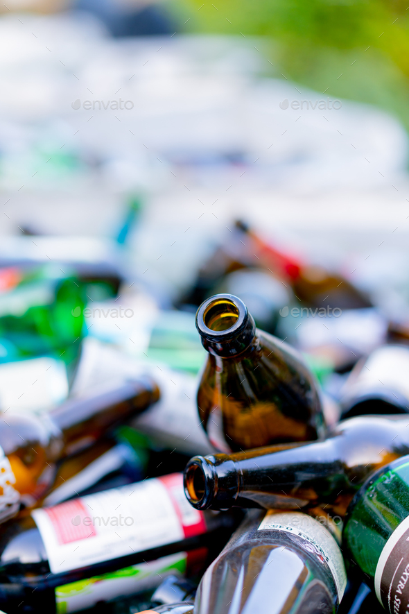 Close-up glass bottles packed in a special garbage bag at waste ...