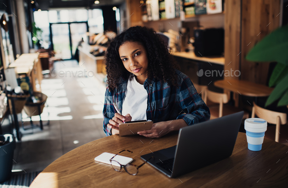 Smiling black woman taking notes in notebook with pen Stock Photo by ...