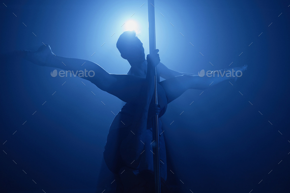 Pole Dancers in Tandem Performance Stock Photo by seventyfourimages