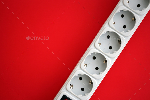 White electrical multi plug extender with european socket on bright red ...