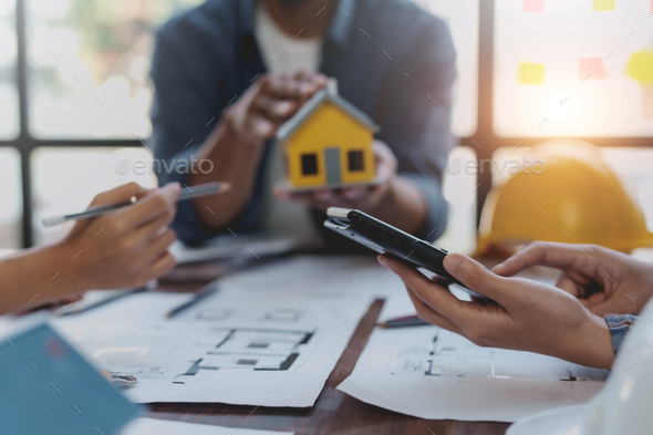 Architect or engineer are meeting to discuss house designs, modify ...