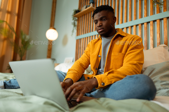 Portrait of handsome African American professional programmer sitting ...