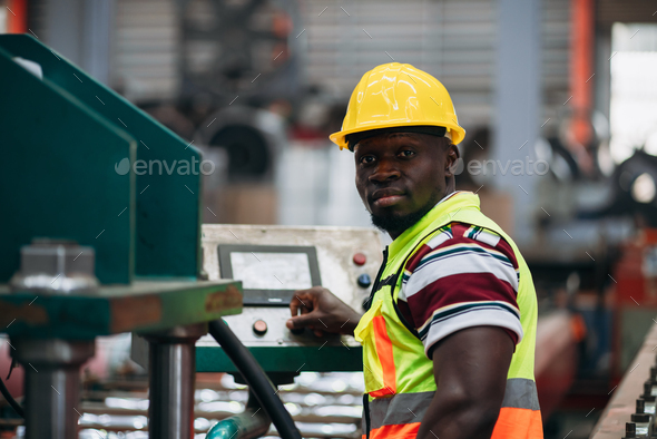 Portrait of industrial worker inspecting and check up machine at ...