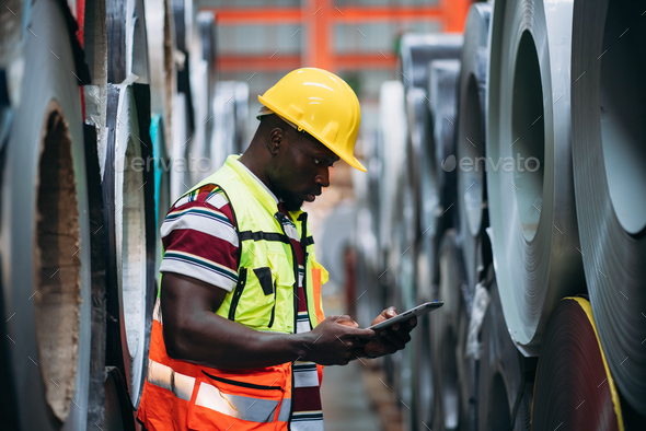 Portrait of industrial worker inspecting and check up machine at ...