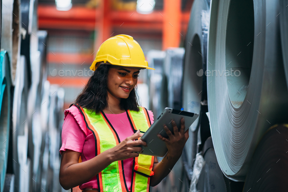Portrait of industrial worker inspecting and check up machine at ...