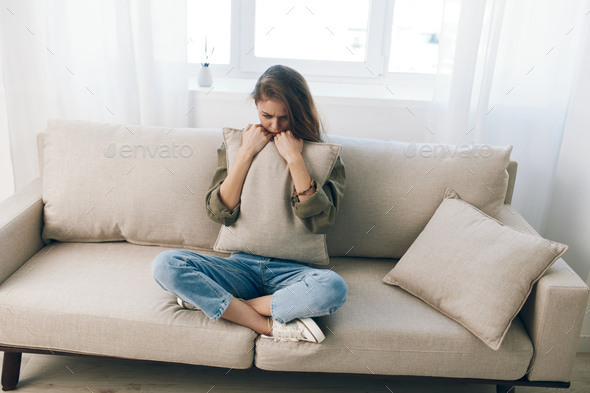 Distressed Woman Resting on Couch, Feeling Sad and Worried, Expressing ...