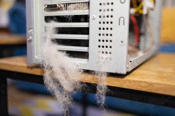 Cobwebs and dust sway in the wind in a computer case against the ...