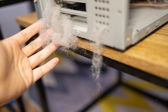 Cobwebs and dust sway in the wind in a computer case against the ...