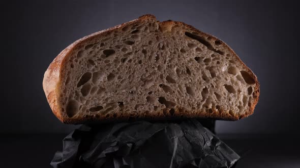 Half Cut Loaf of Sourdough Bread Spinning With Black Background ...