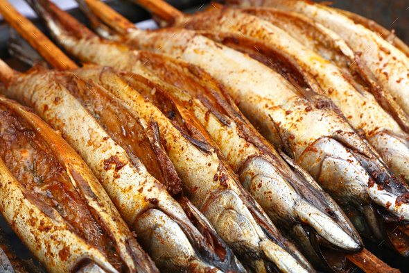Cooking bonito mackerel fish on grill Stock Photo by BreakingTheWalls
