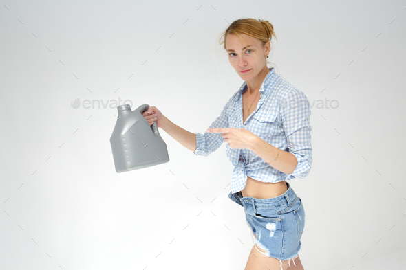 Woman holding canister of motor oil on light background Stock Photo by ...