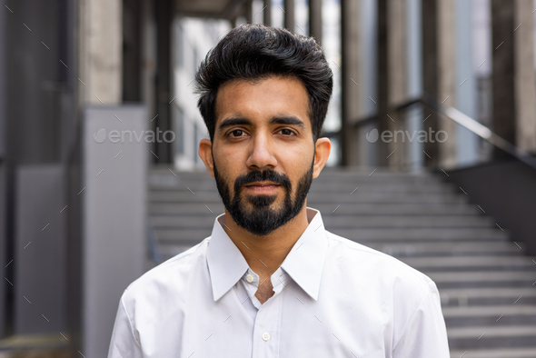 Portrait of a close young businessman, outside the office building, a ...