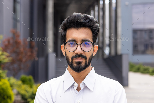 Portrait of a close young businessman, outside the office building, a ...