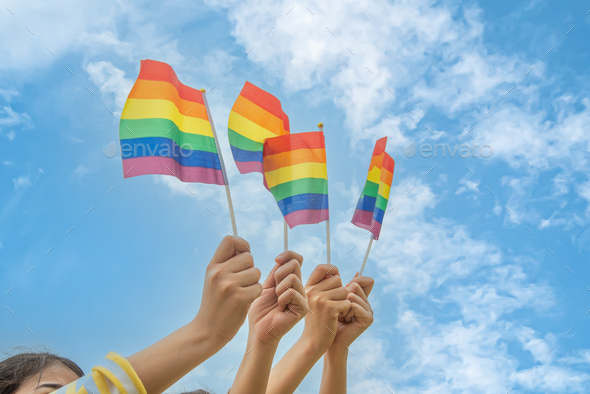 Diversity people hands raising colorful lgbtq rainbow flags together ...