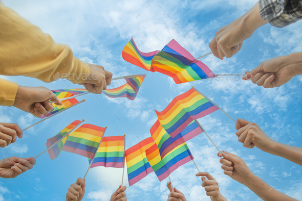 Diversity people hands raising colorful lgbtq rainbow flags together ...