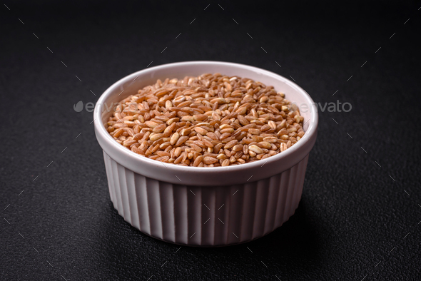 Large grains of wheat porridge are brown in color when raw Stock Photo ...