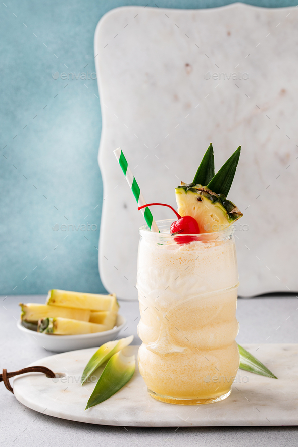 Tropical pina colada cocktail or mocktail in a tiki glass Stock Photo ...