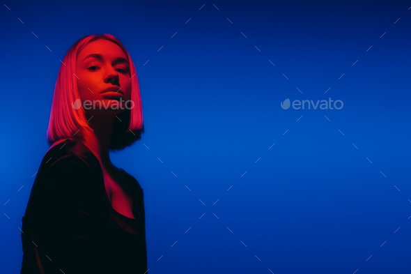 Neon Glow: Portrait of a Woman in Blue Ambiance Stock Photo by arthurhidden