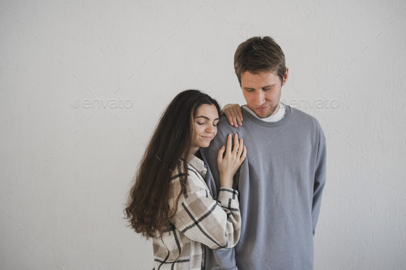 Young Couple Sharing an Intimate Hug on a simple backround Stock Photo ...