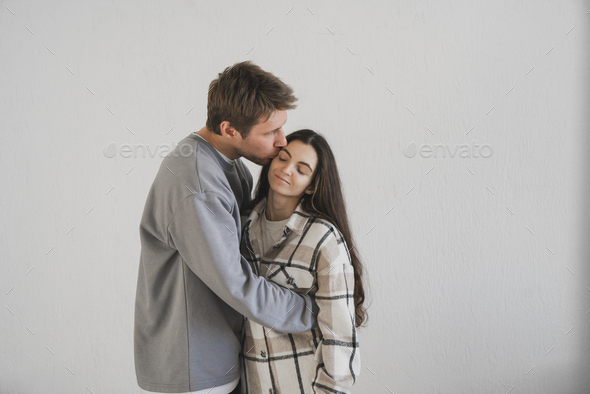 Young Couple Sharing an Intimate Hug on a simple backround Stock Photo ...