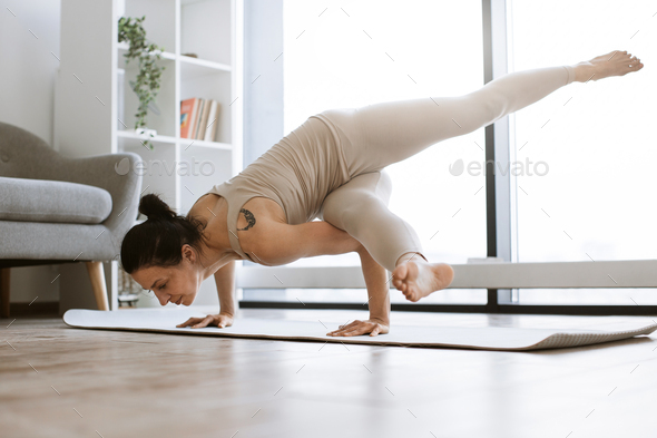 Brunette practicing various position body endurance and balance while ...