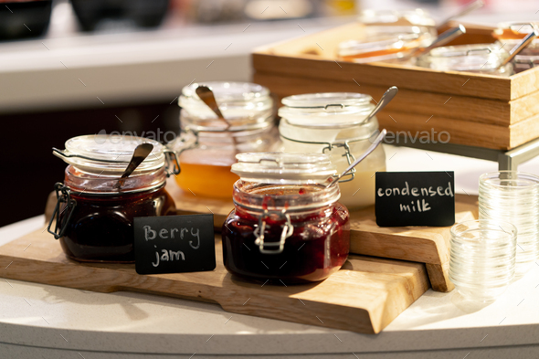 close-up breakfast buffet line serving a variety of jams in a hotel ...