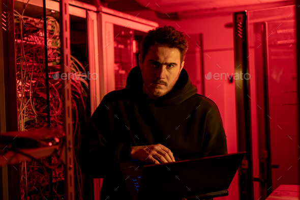 focused hacker in data center hacking software system vulnerable cyber ...