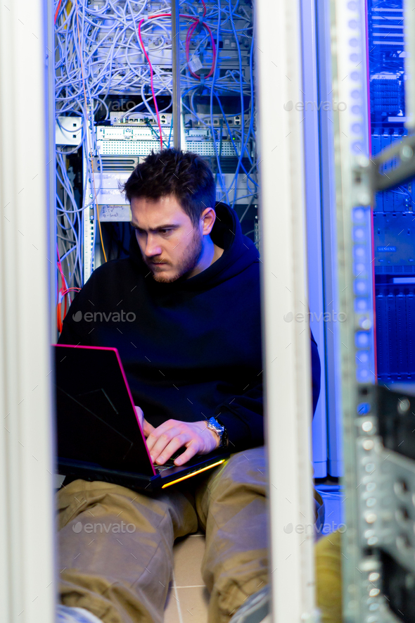 focused hacker in data center hacking software system vulnerable cyber ...
